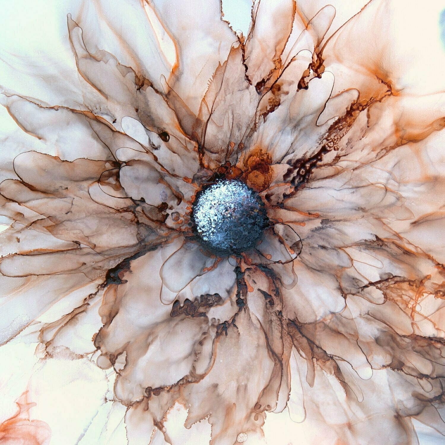 An orange flower with a white core, done in vibrant alcohol inks